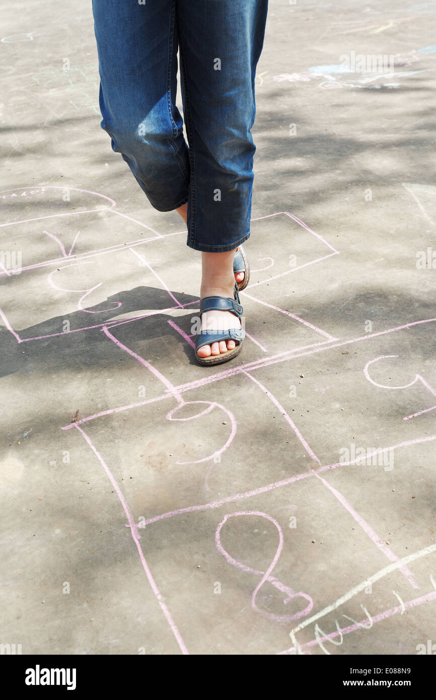 girl hopping in hopscotch outdoors in sunny day Stock Photo - Alamy