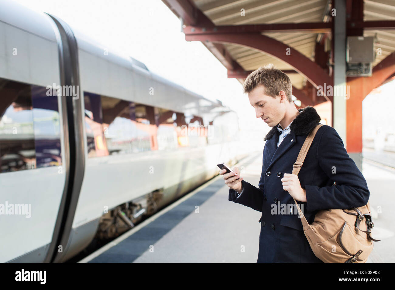 Businessman texting railroad station hi-res stock photography and ...