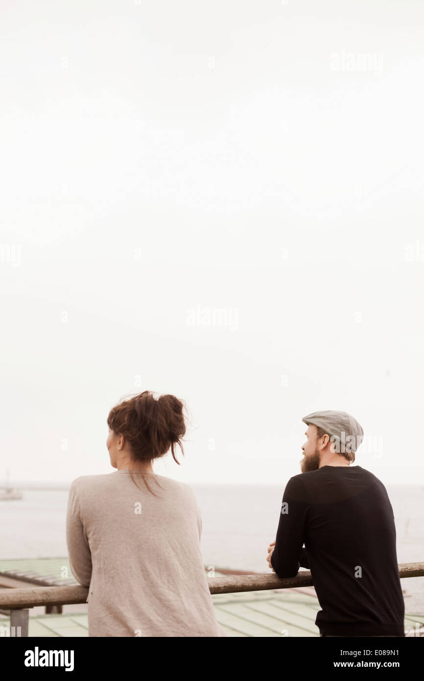 Men lean against railing outside hi-res stock photography and images ...