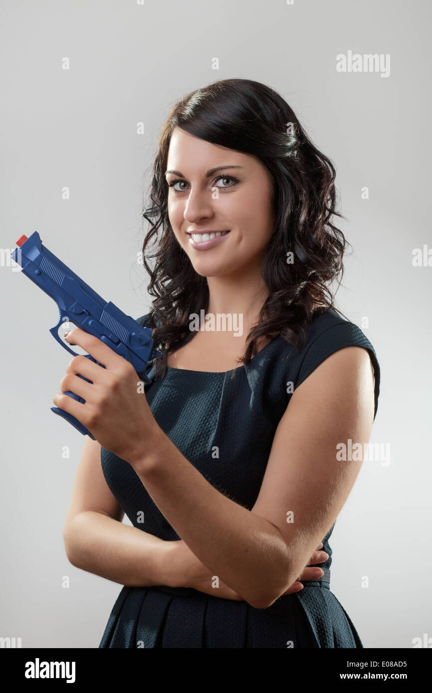 office worker holding a toy gun looking at camera Stock Photo - Alamy