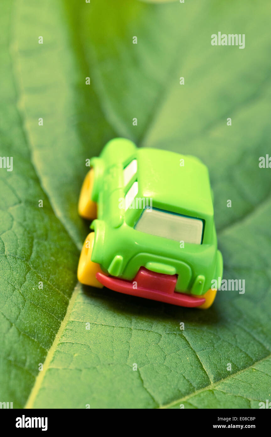 small green toy car on a leaf, green car concept Stock Photo - Alamy