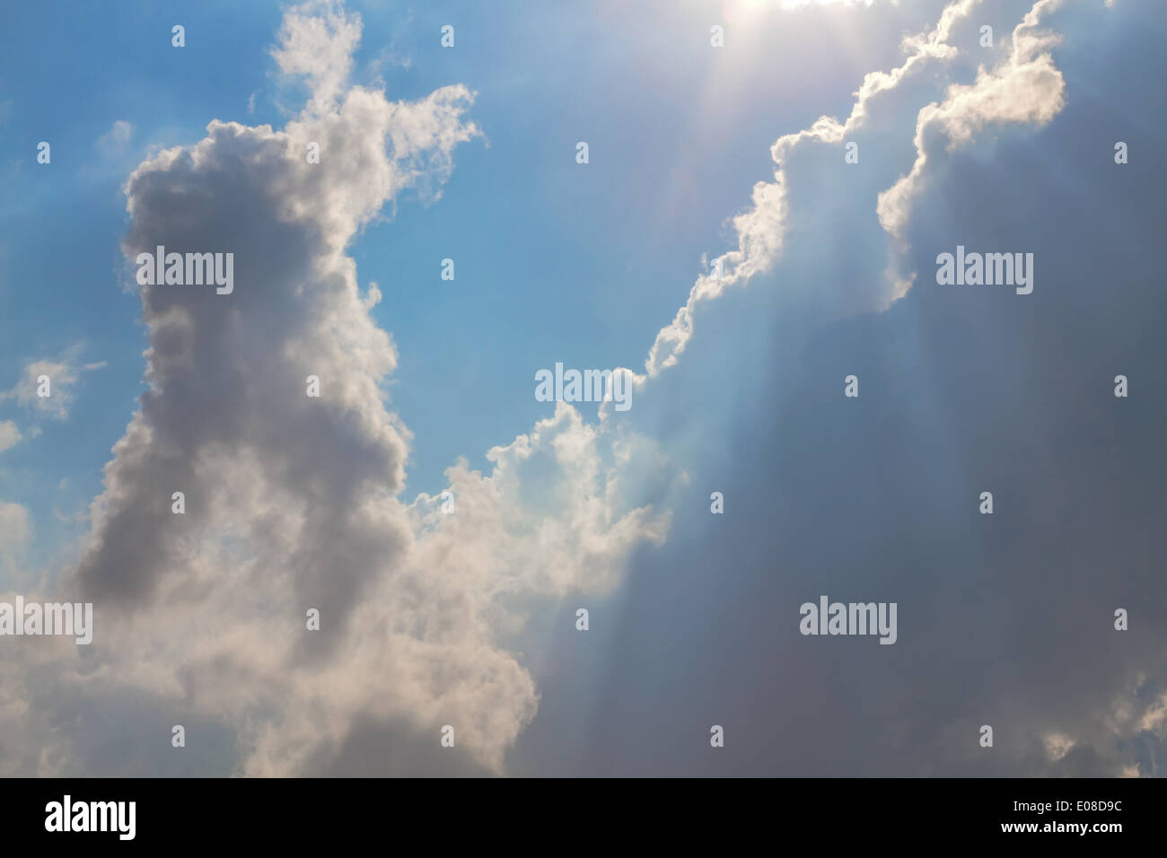 Sun under clouds on blue sky background Stock Photo - Alamy