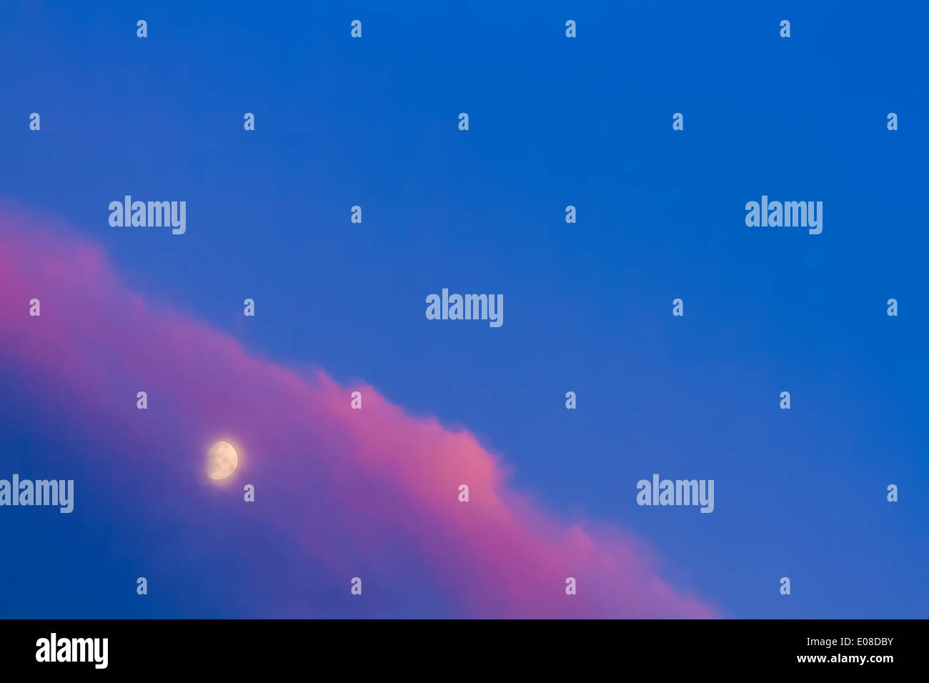 Moon under pink cloud on blue sky background Stock Photo - Alamy