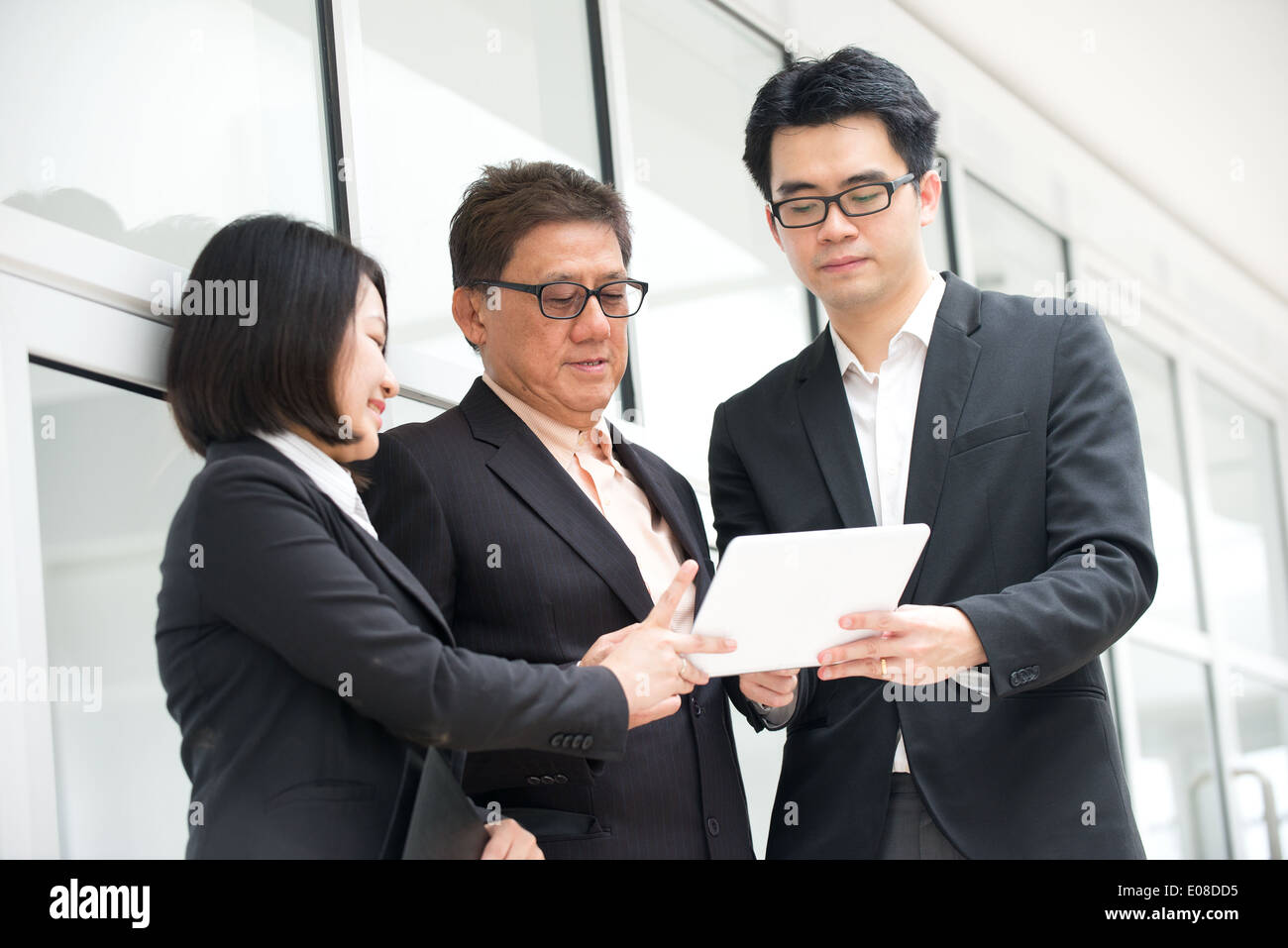 chinese business team meeting over office background Stock Photo - Alamy