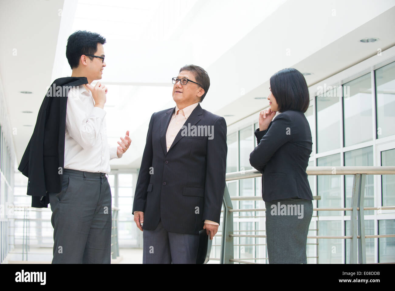 asian business team meeting over their office Stock Photo - Alamy