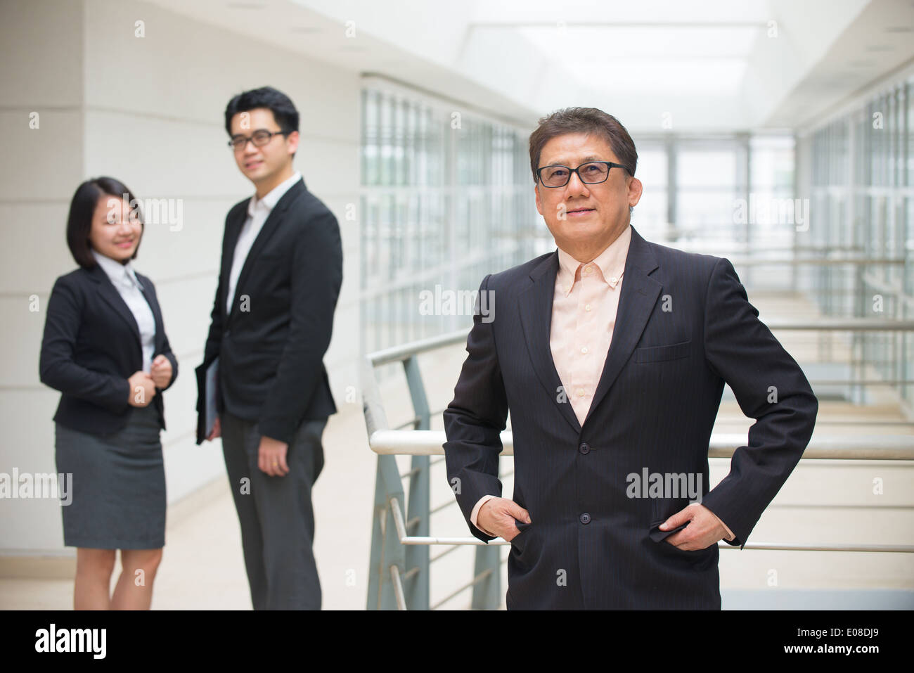 senior asian business ceo with team on background Stock Photo - Alamy