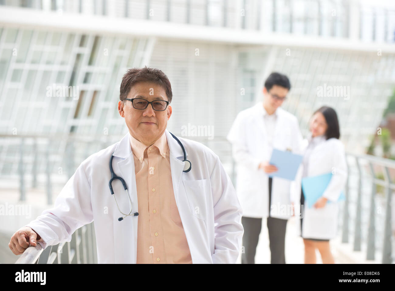 chinese asian medical team over hospital background Stock Photo - Alamy
