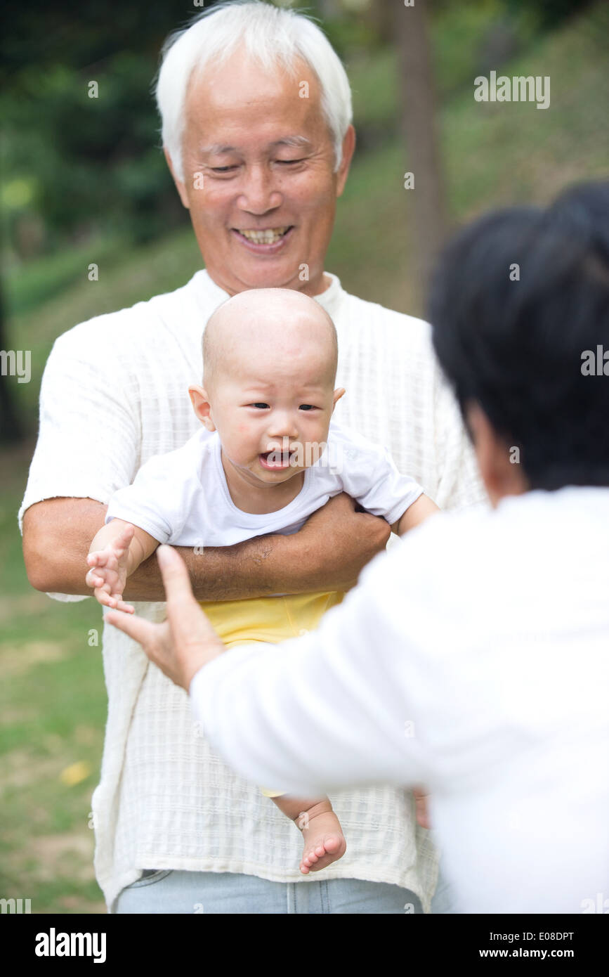 asian grandparents playing with baby grandson at outdoor Stock Photo ...