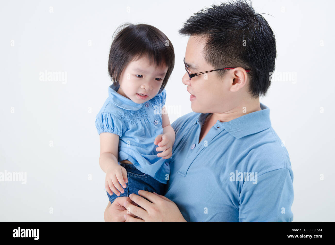 asian father and daughter on plain background Stock Photo - Alamy