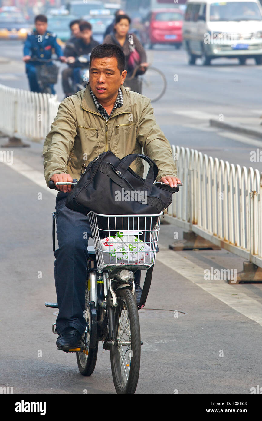Chinese Man Cycling In The Morning Beijing Rush Hour Stock Photo - Alamy
