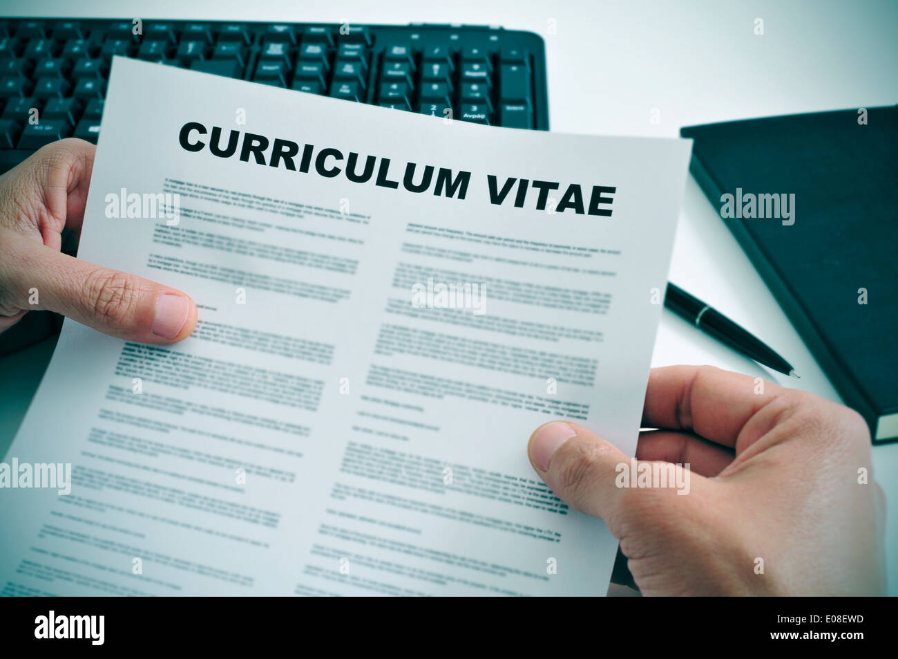 man in his office checking a curriculum vitae Stock Photo - Alamy