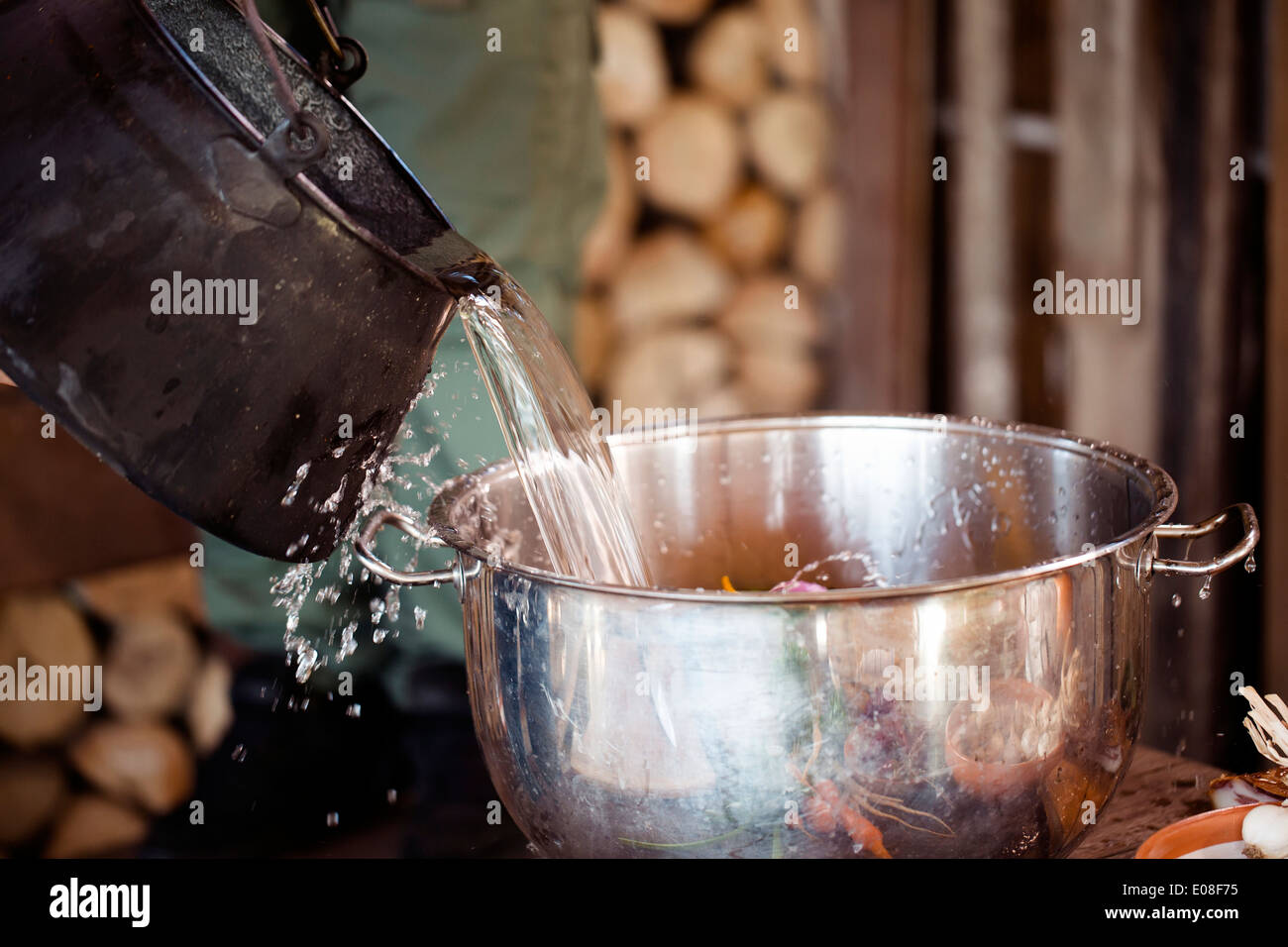 Pouring water in cooking pot Stock Photo - Alamy