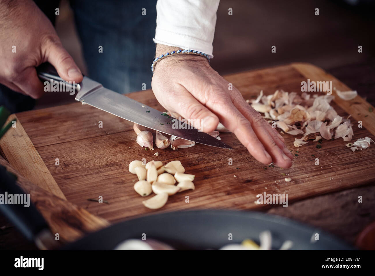 Unrecognizable person cutting garlic Stock Photo - Alamy