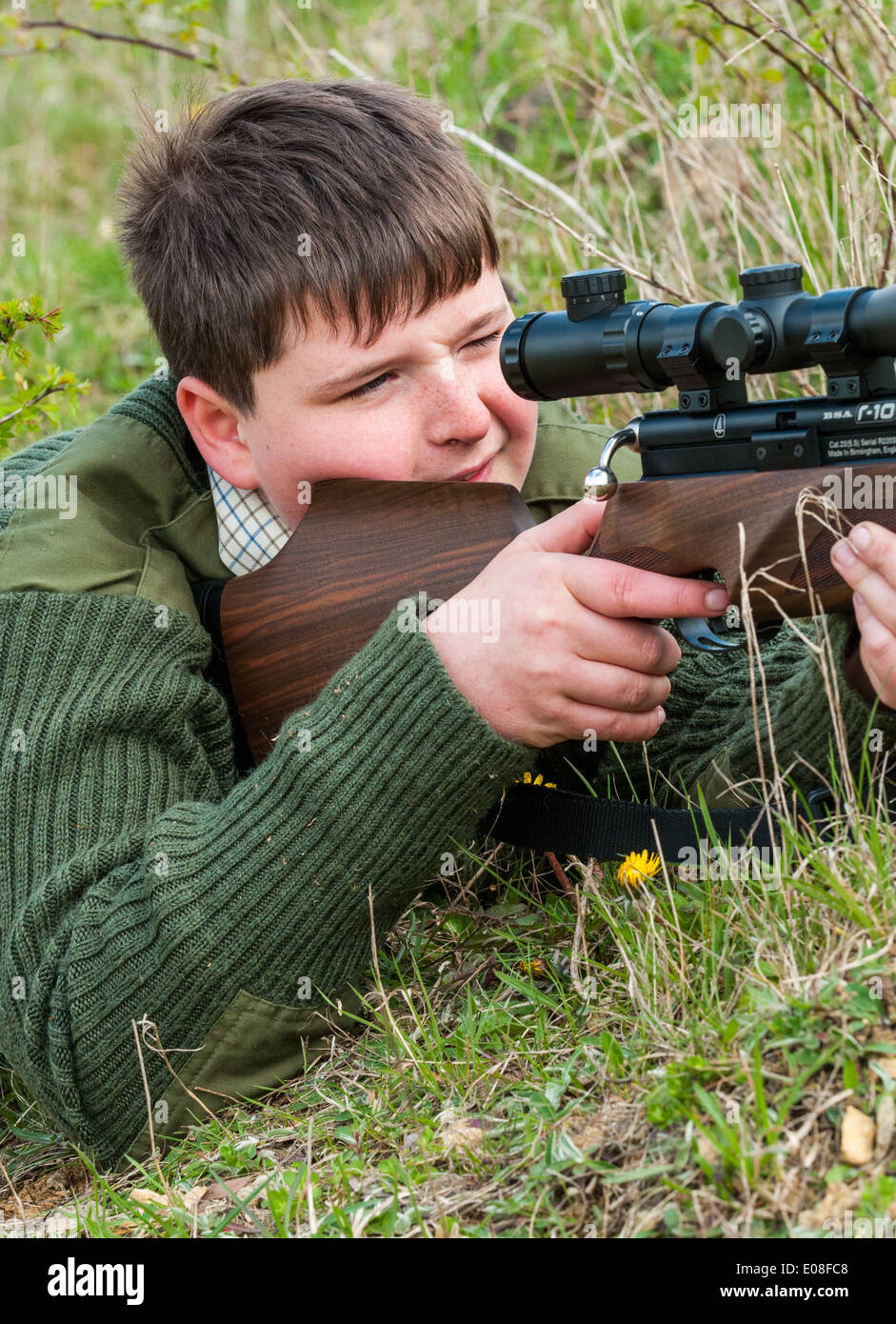 A young boy with an air rifle shooting Stock Photo - Alamy