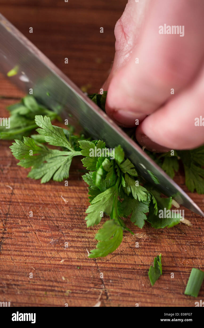 Person Cutting parsley, close-up Stock Photo - Alamy