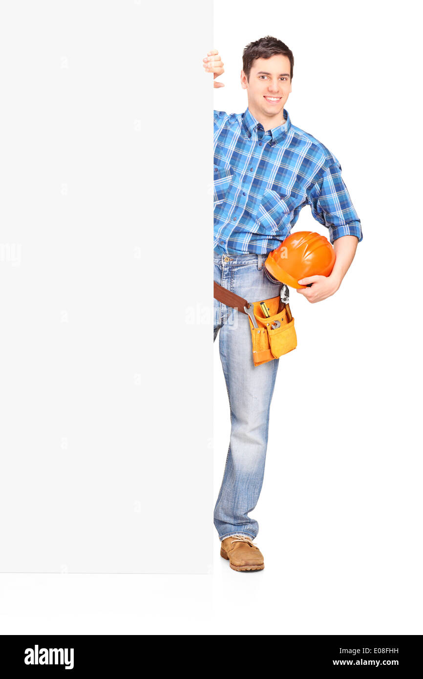 Male construction worker standing behind blank panel Stock Photo - Alamy