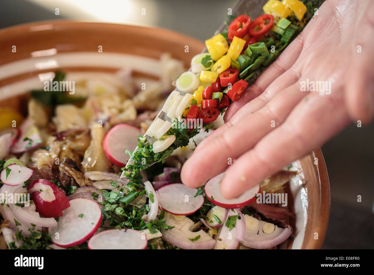 Person adding ingredients to food Stock Photo - Alamy