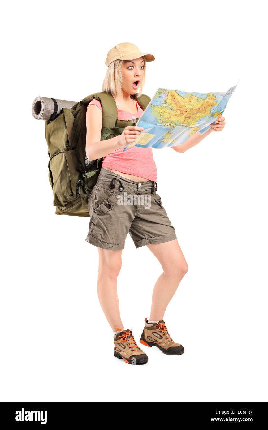 Surprised female hiker looking at a map Stock Photo - Alamy