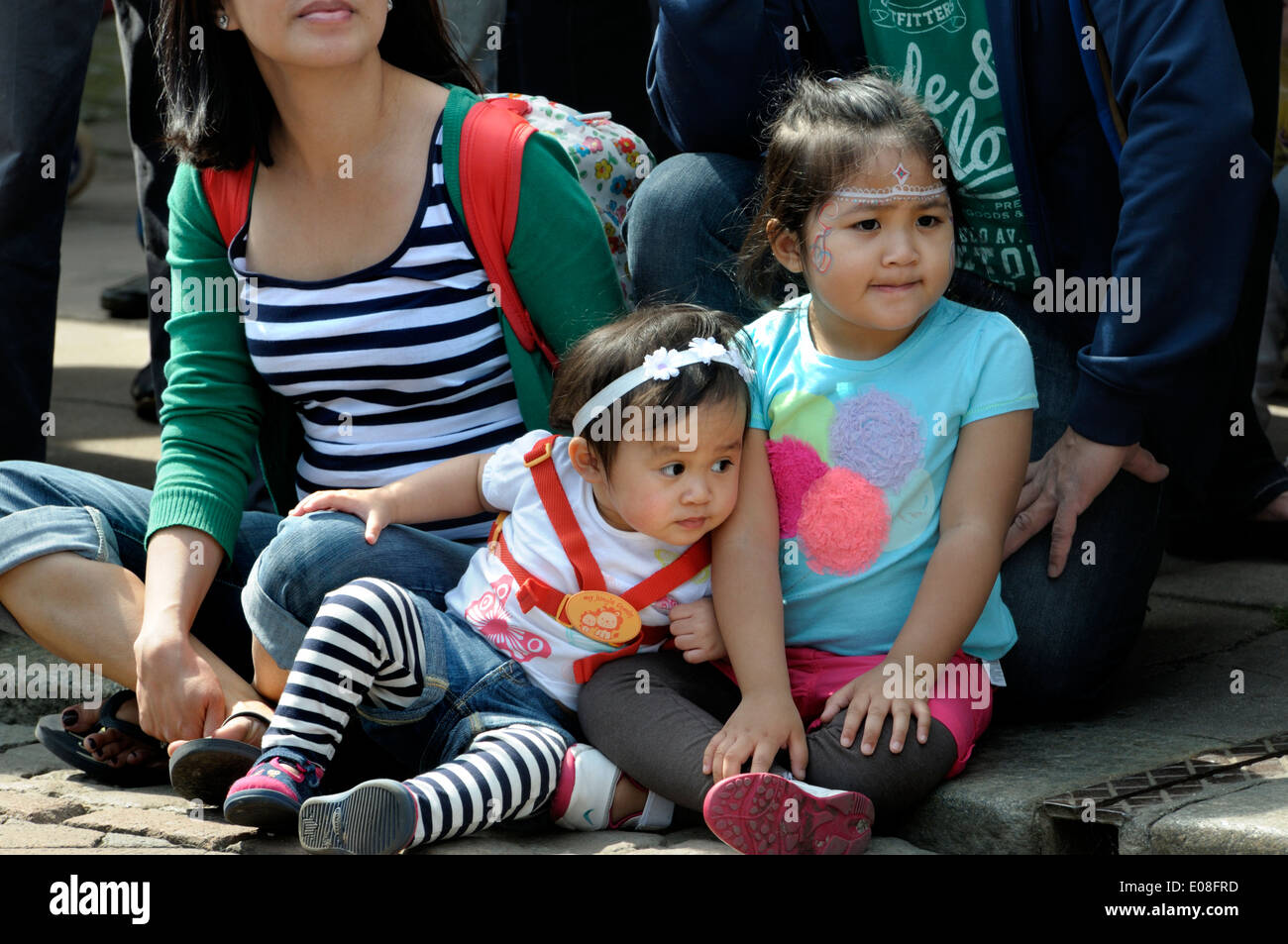 Rochester, Kent, England, UK. Young Asian family in the crowd at an ...