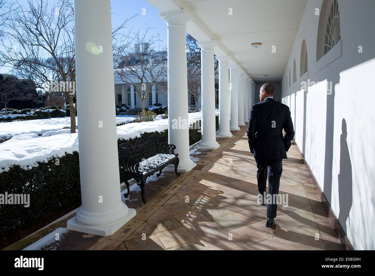 US President Barack Obama walks alone on a winter day along the ...