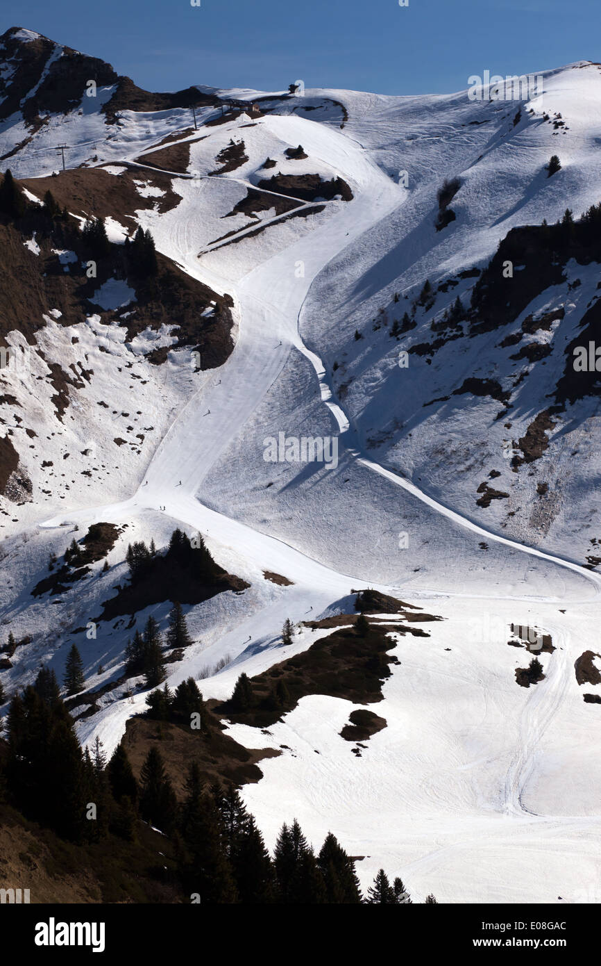 A dramatic, telephoto, view of Les Arbis red ski run in the Alpine ...