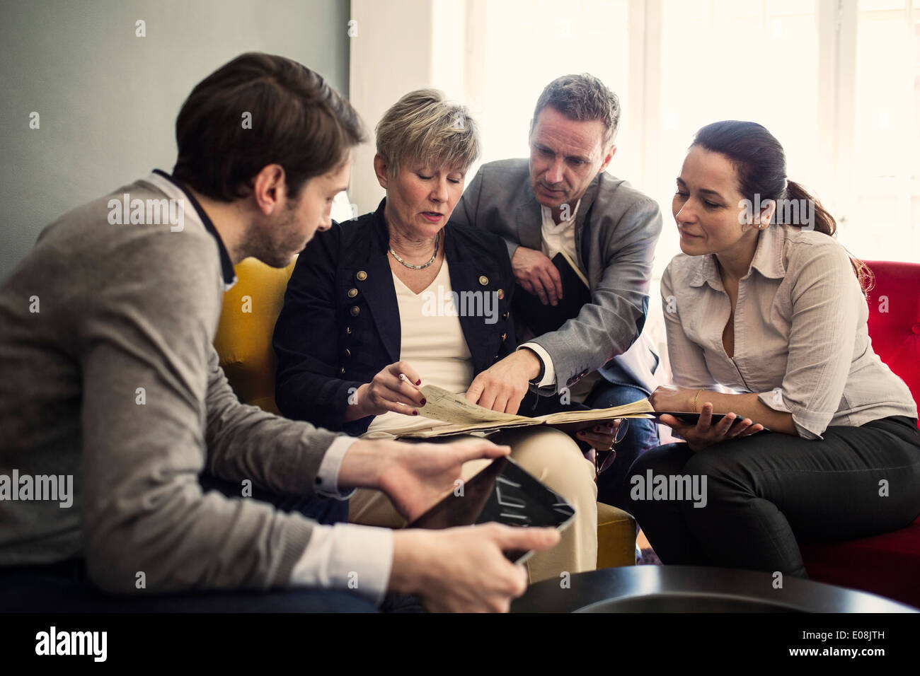 Business team discussing in office lobby Stock Photo - Alamy