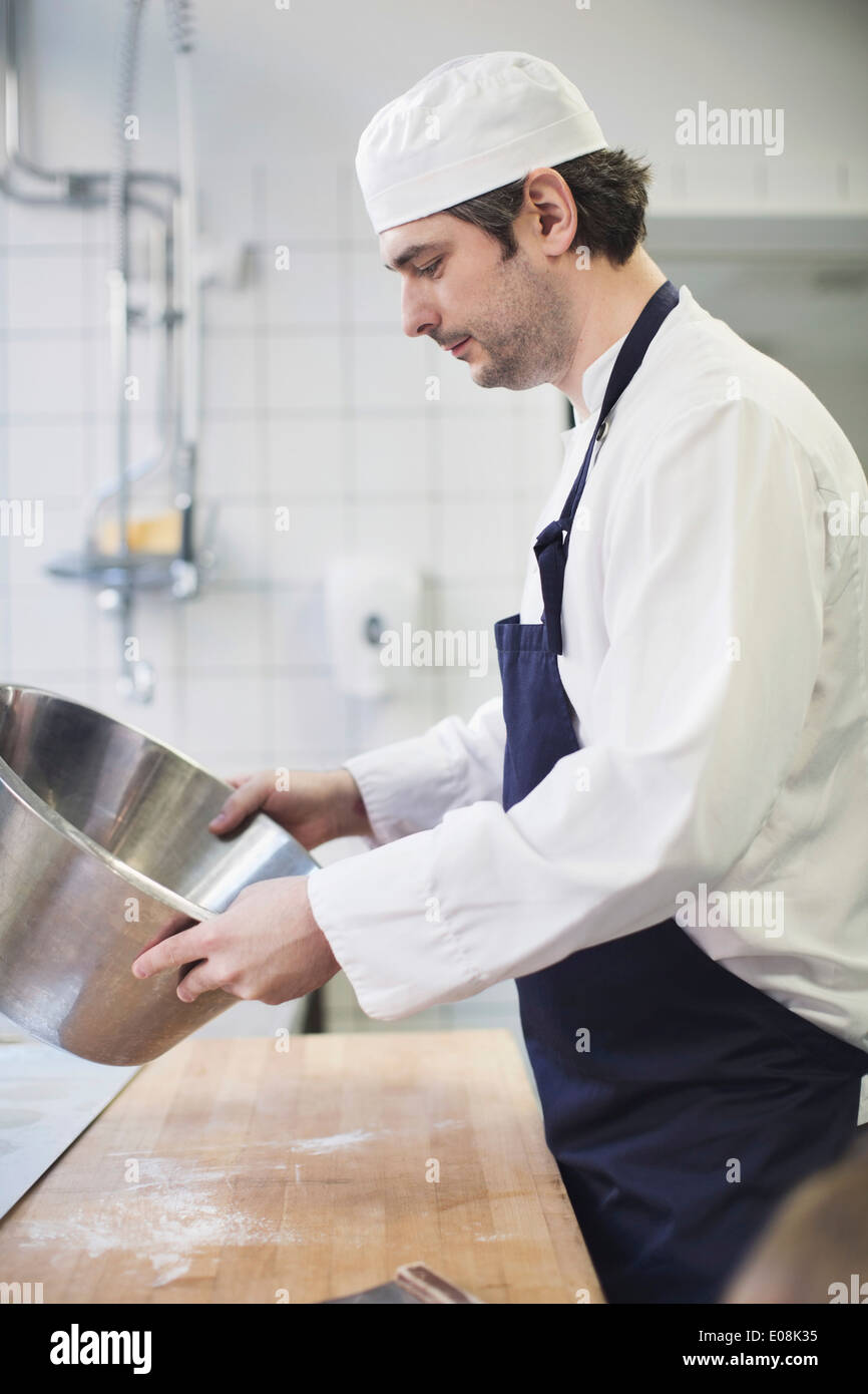Side view of male baker working in commercial kitchen Stock Photo - Alamy