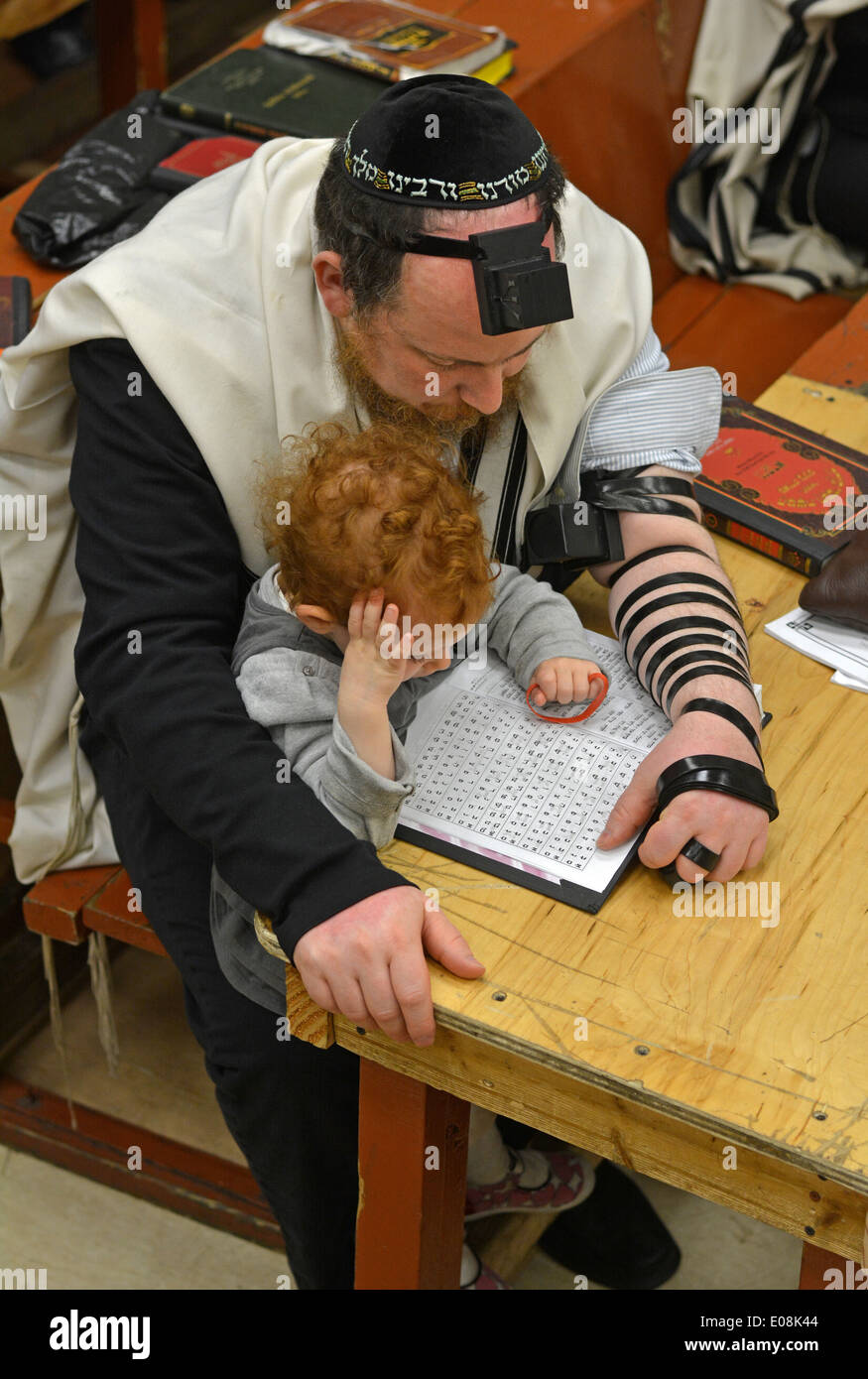 Religious Jewish father and child reading in the synagogue In Brooklyn ...