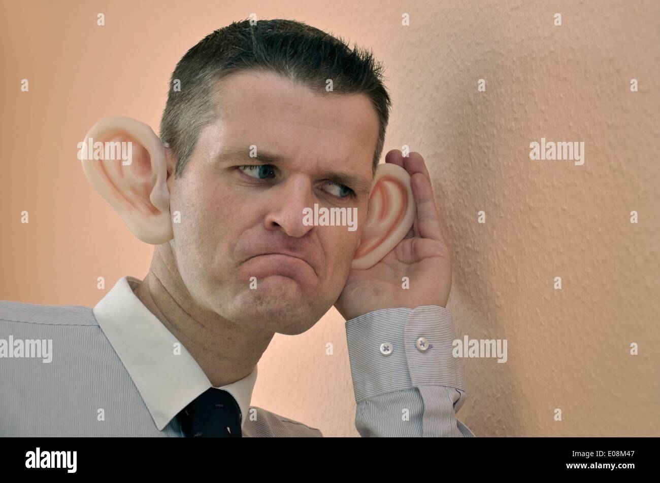 Illustration - A man wearing giant rubber ears spies on a wall in ...