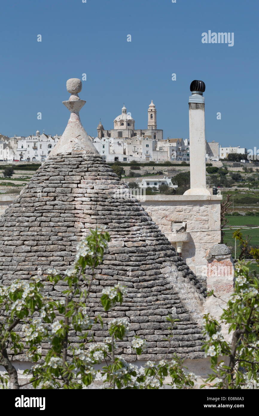 Roof of traditional trullo with Locorotondo in distance, Puglia, Italy ...