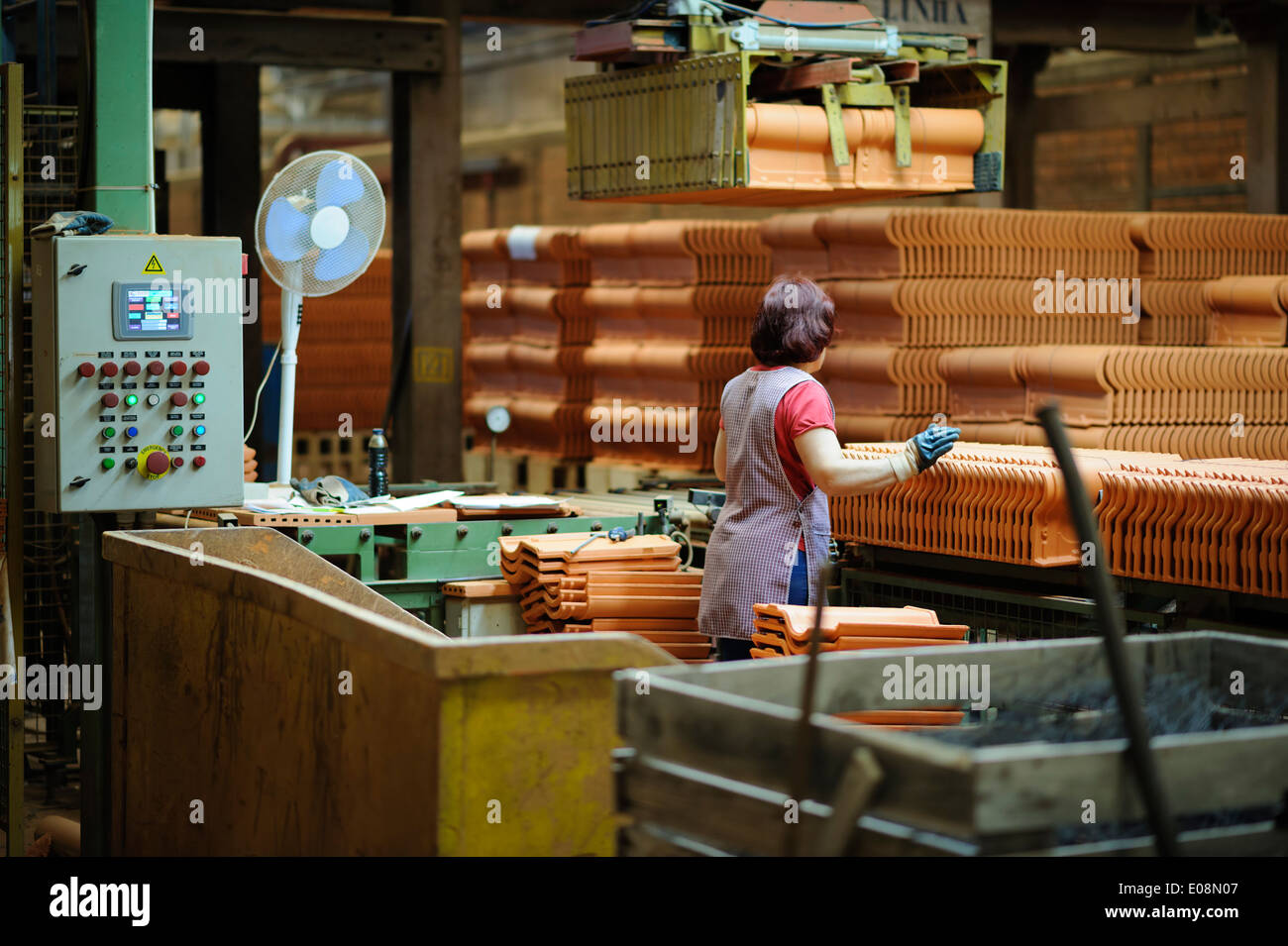 Woman working at clay roof tiles factory Stock Photo - Alamy