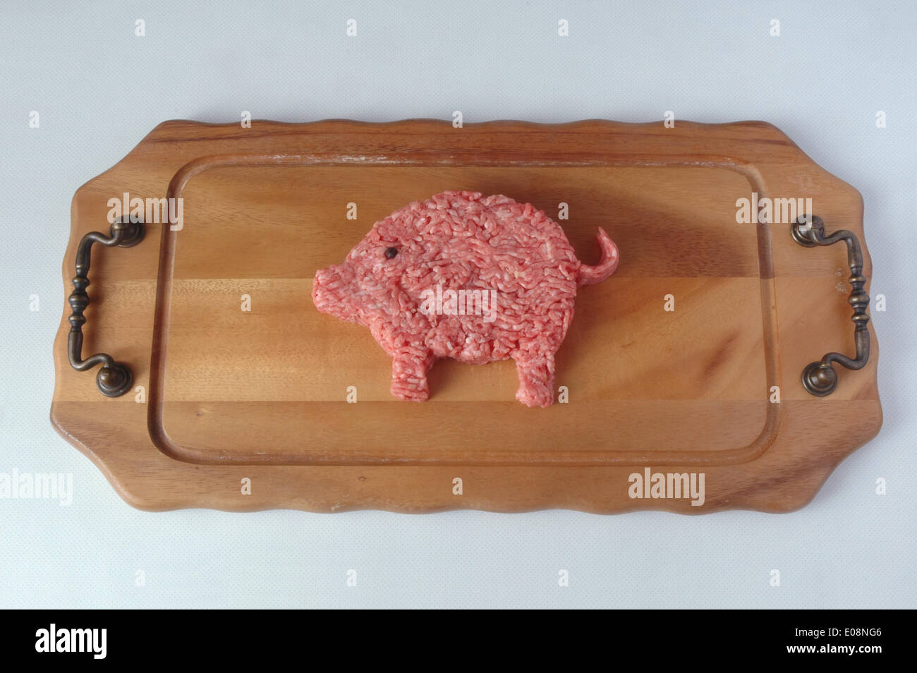 Illustration - Minced meat in shape of a pig lies on a chopping board ...
