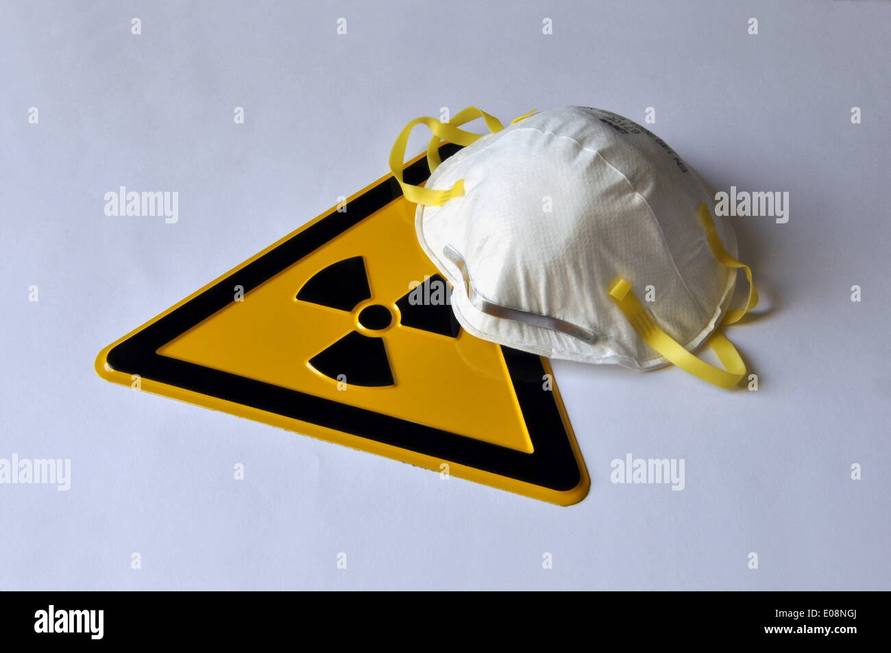 Illustration - A radioactive trefoil symbol sits next to a respirator ...