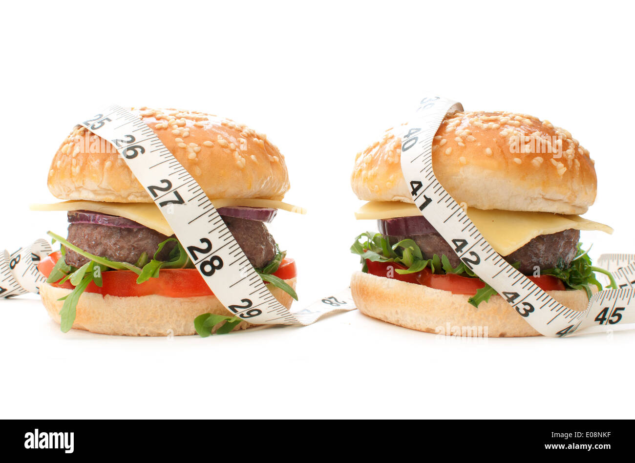 Two burgers with measuring tape Stock Photo - Alamy
