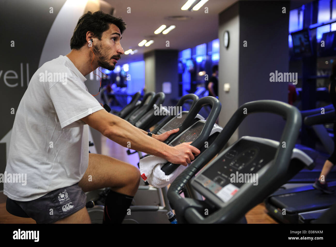Person working out on exercise bike at the gym Stock Photo - Alamy