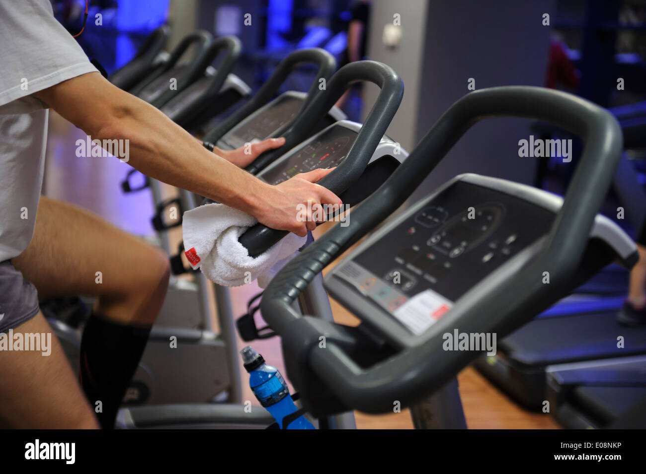 Person working out on exercise bike at the gym Stock Photo - Alamy