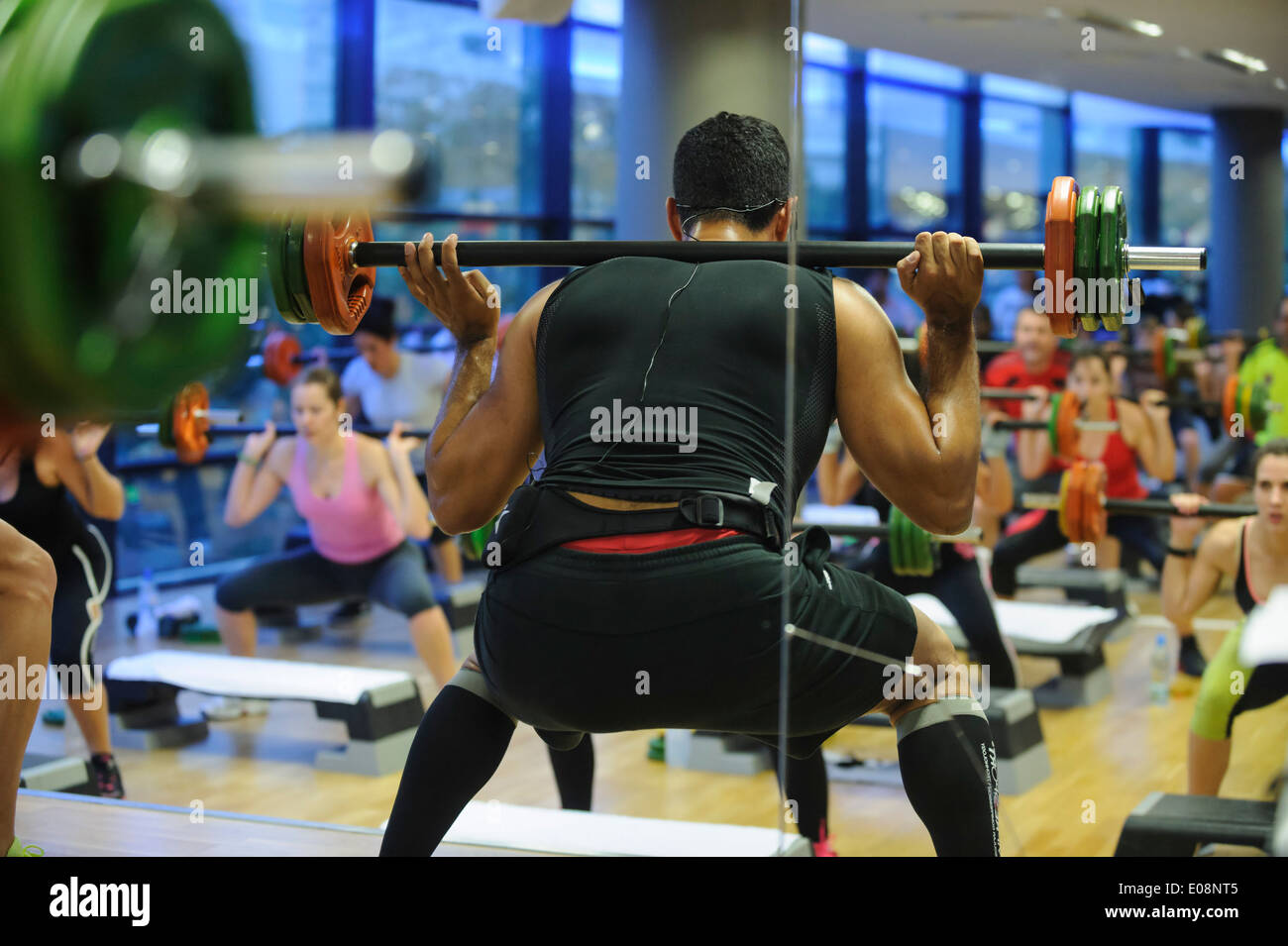 Fitness instructor's reflection in the mirror of a gym during a Body ...