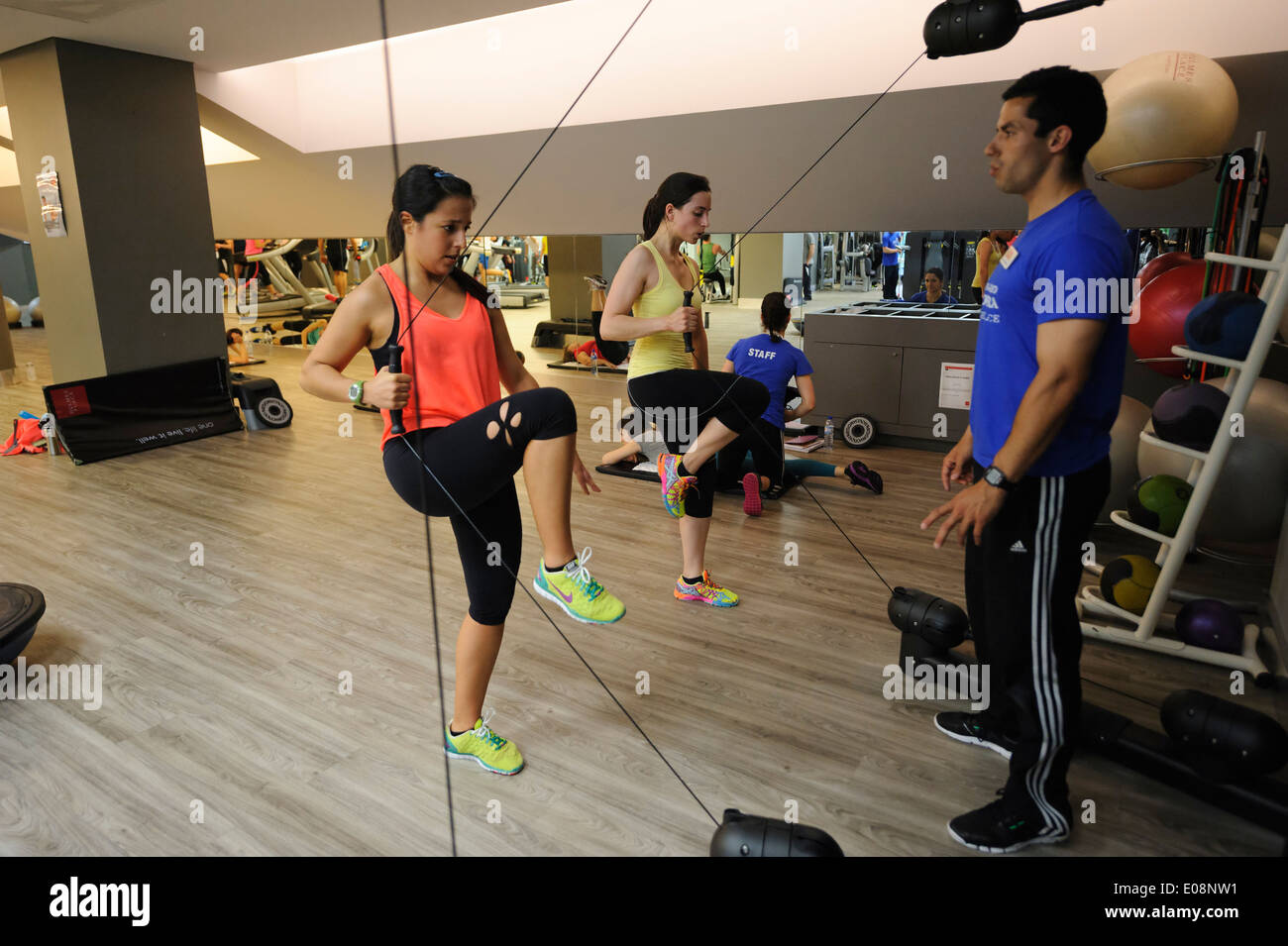 Personal trainer with clients at the gym Stock Photo - Alamy