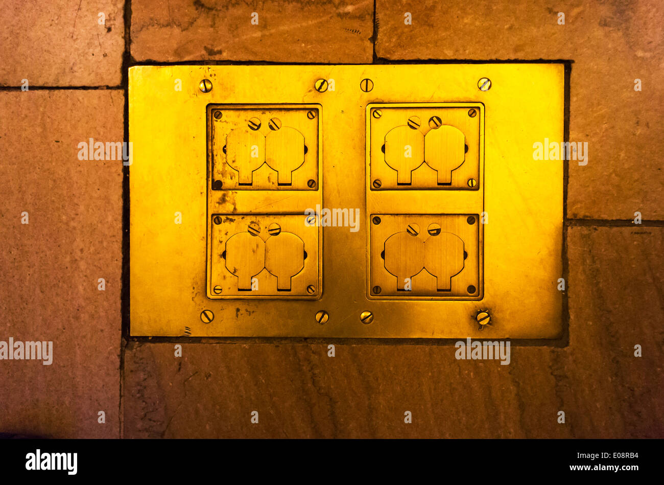 Brass covered electrical outlets inset into the floor in New York on ...