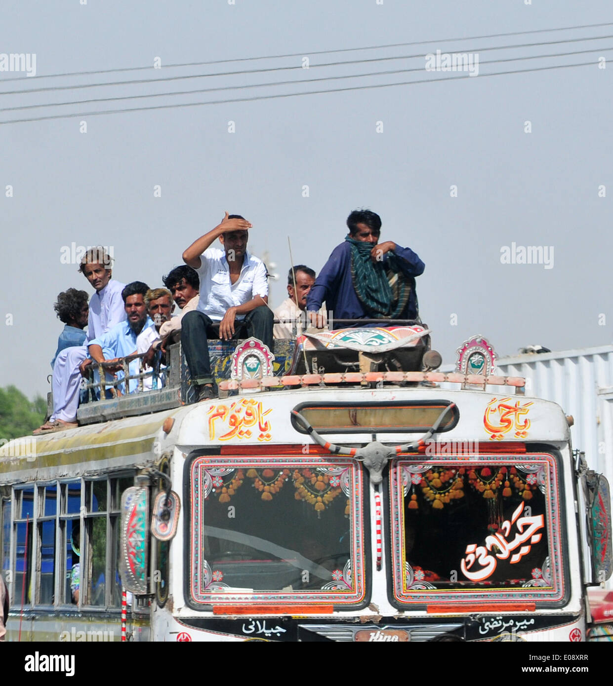 Karachi. 6th May, 2014. People sit on the roof of an overloaded bus in ...