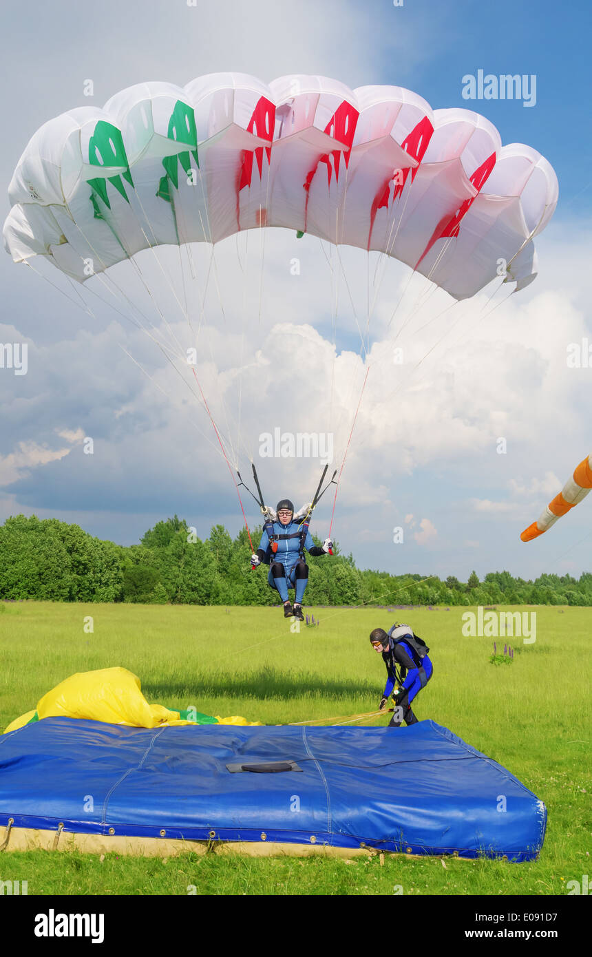 One day with parachutist in airfield. The skydiver lands under the ...