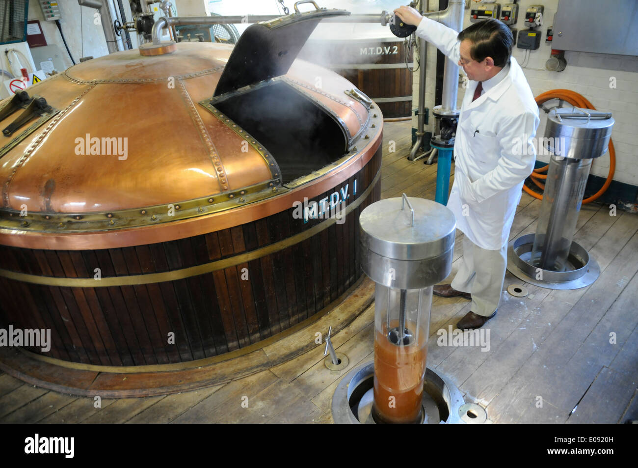 Head Brewer at Harveys of Sussex Brewery inspecting the brewing process ...