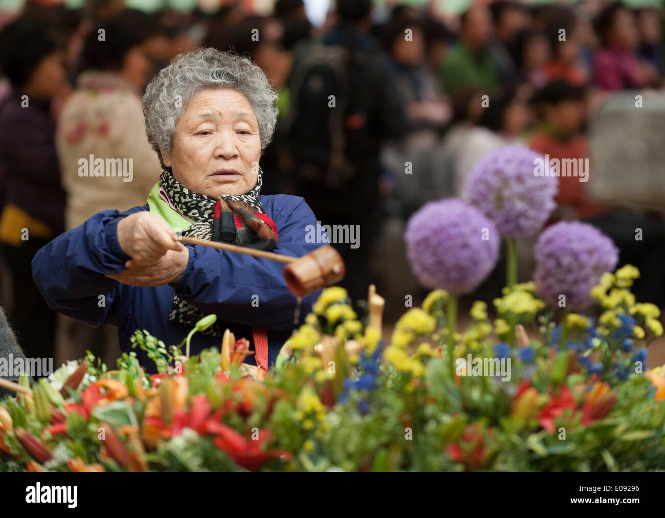 Busan, South Korea. 6th May, 2014. A woman pours water over a statue of ...