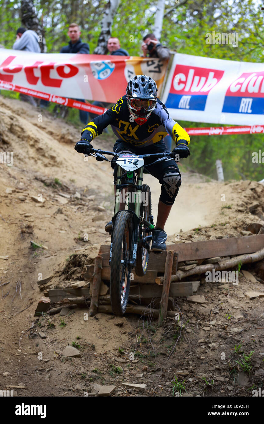 Rider jumping on dirt track. Down Hill mountain biking race in ...