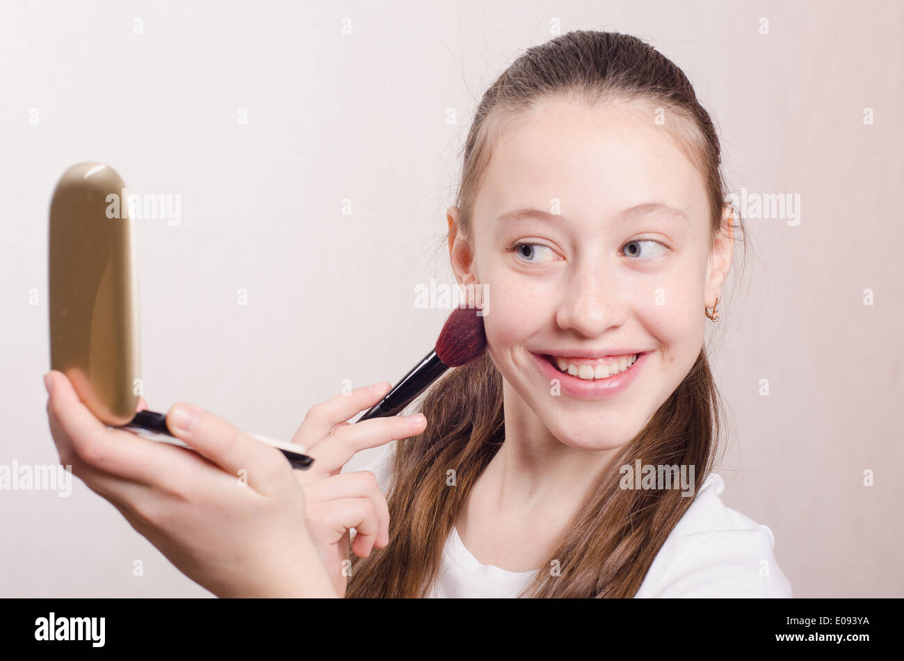 Teen girl having a fun painted cosmetics Stock Photo - Alamy