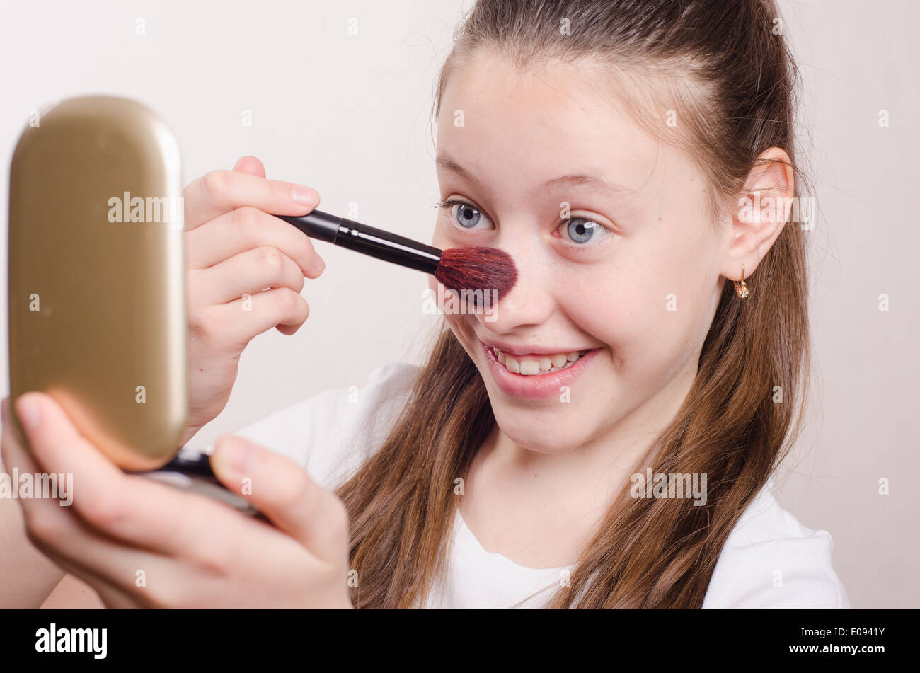 Teen girl having a fun painted cosmetics Stock Photo - Alamy