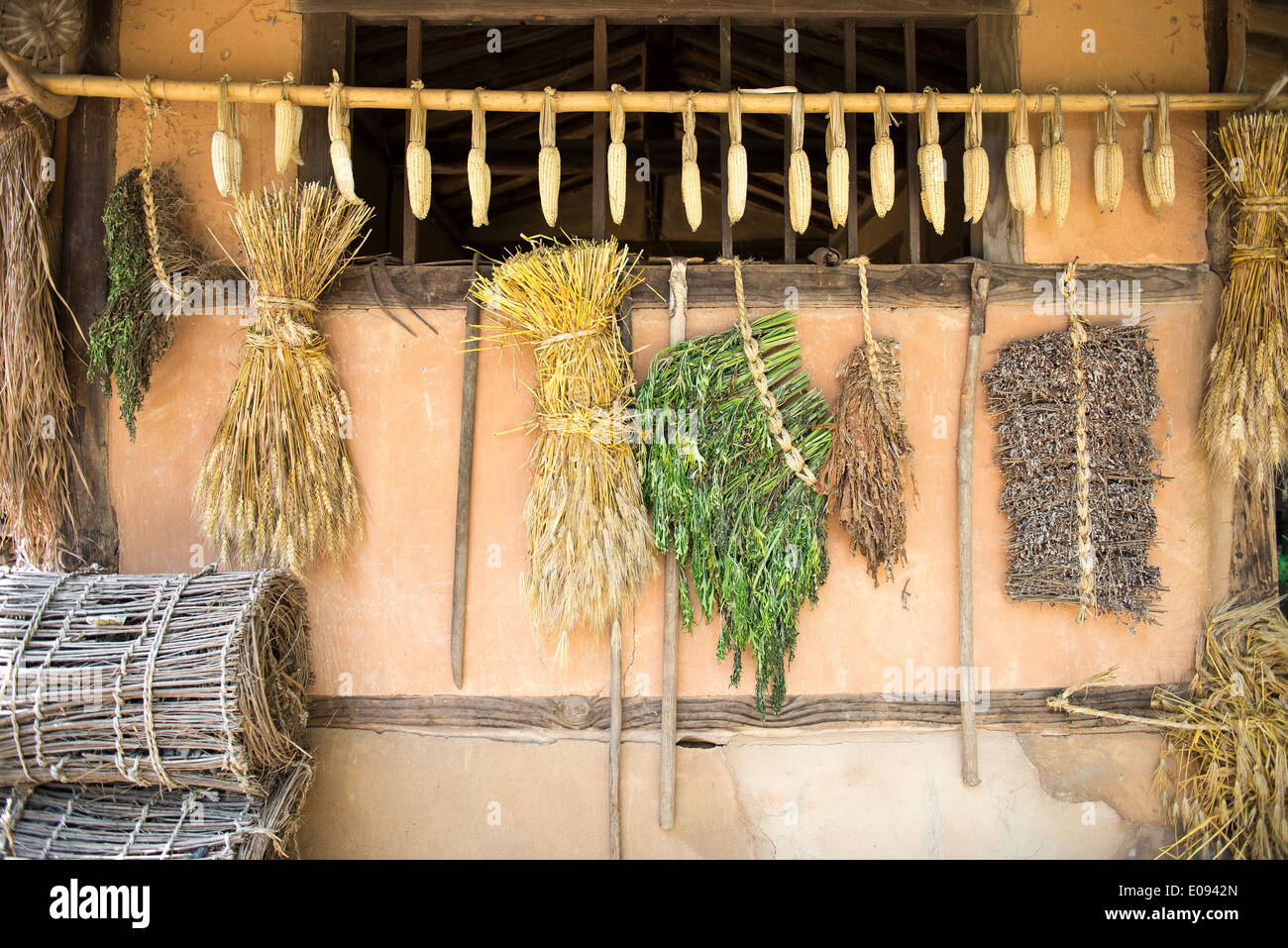 Wall of an old house with drying corn and vegetables Stock Photo - Alamy