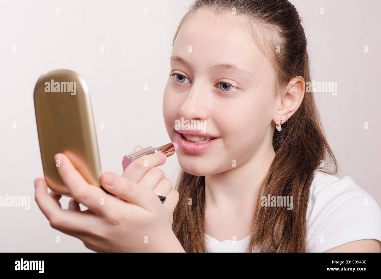 Teen girl having a fun painted cosmetics Stock Photo - Alamy