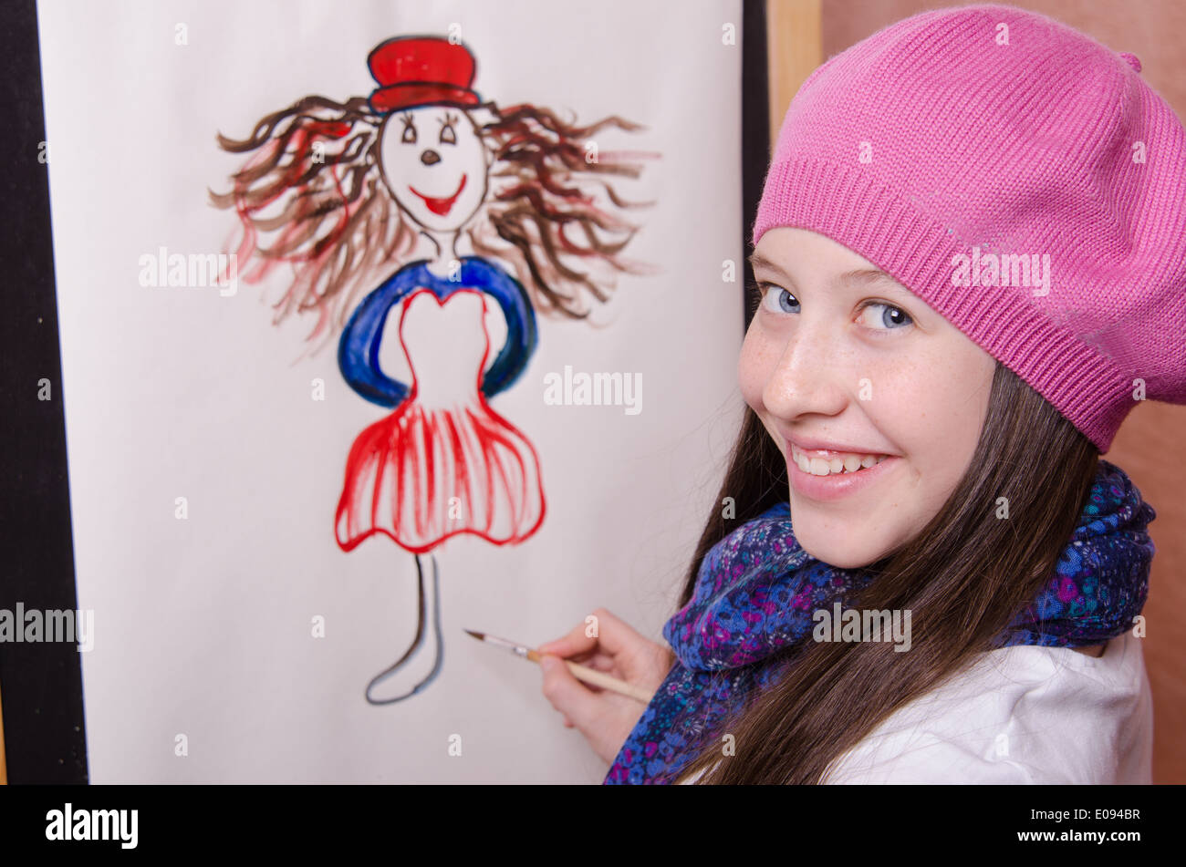 Twelve year old girl draws a picture on the easel Stock Photo - Alamy