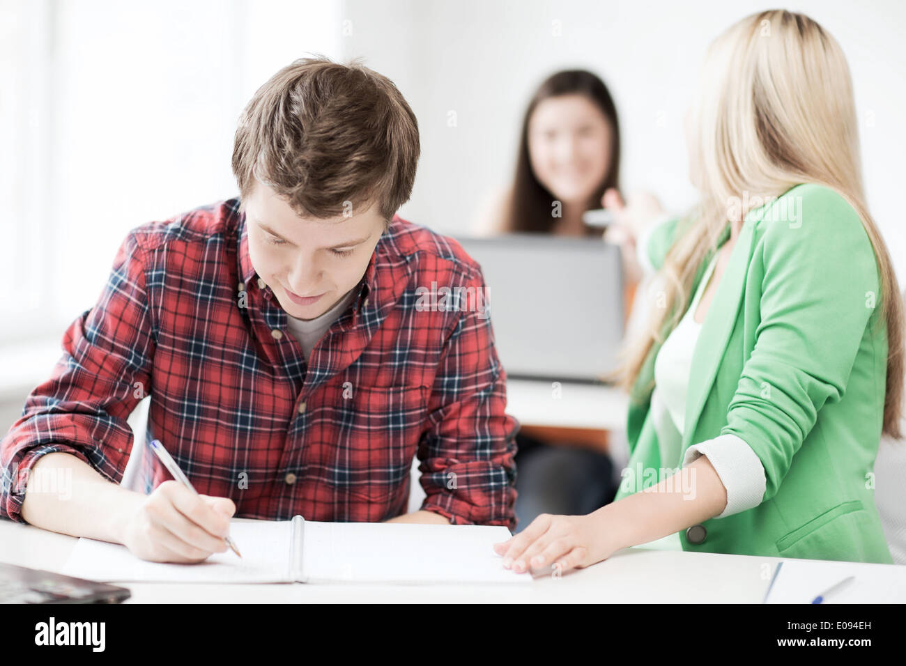 students writing something at school Stock Photo - Alamy